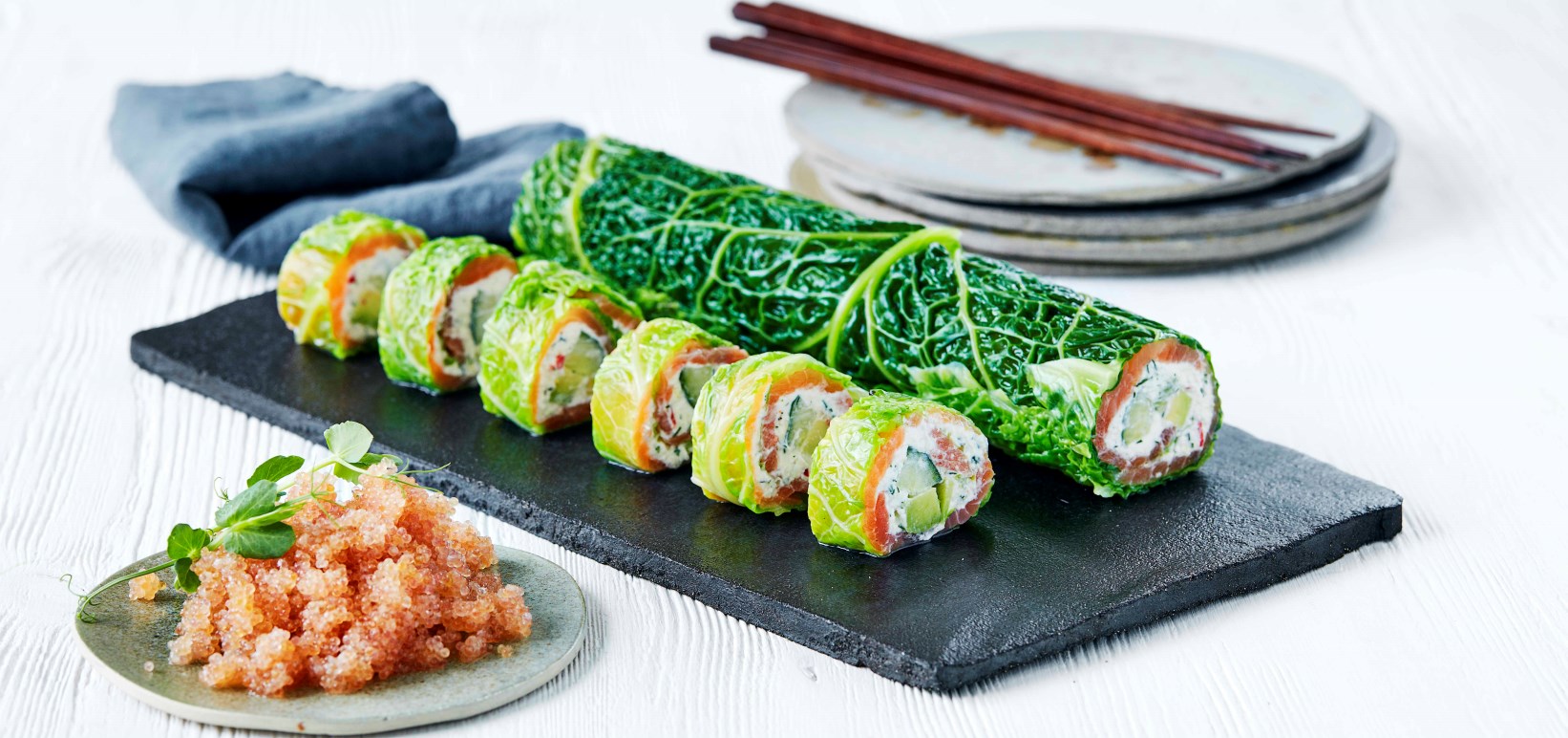 Cold smoked salmon sushi rolls with savoy cabbage, horseradish cream ...